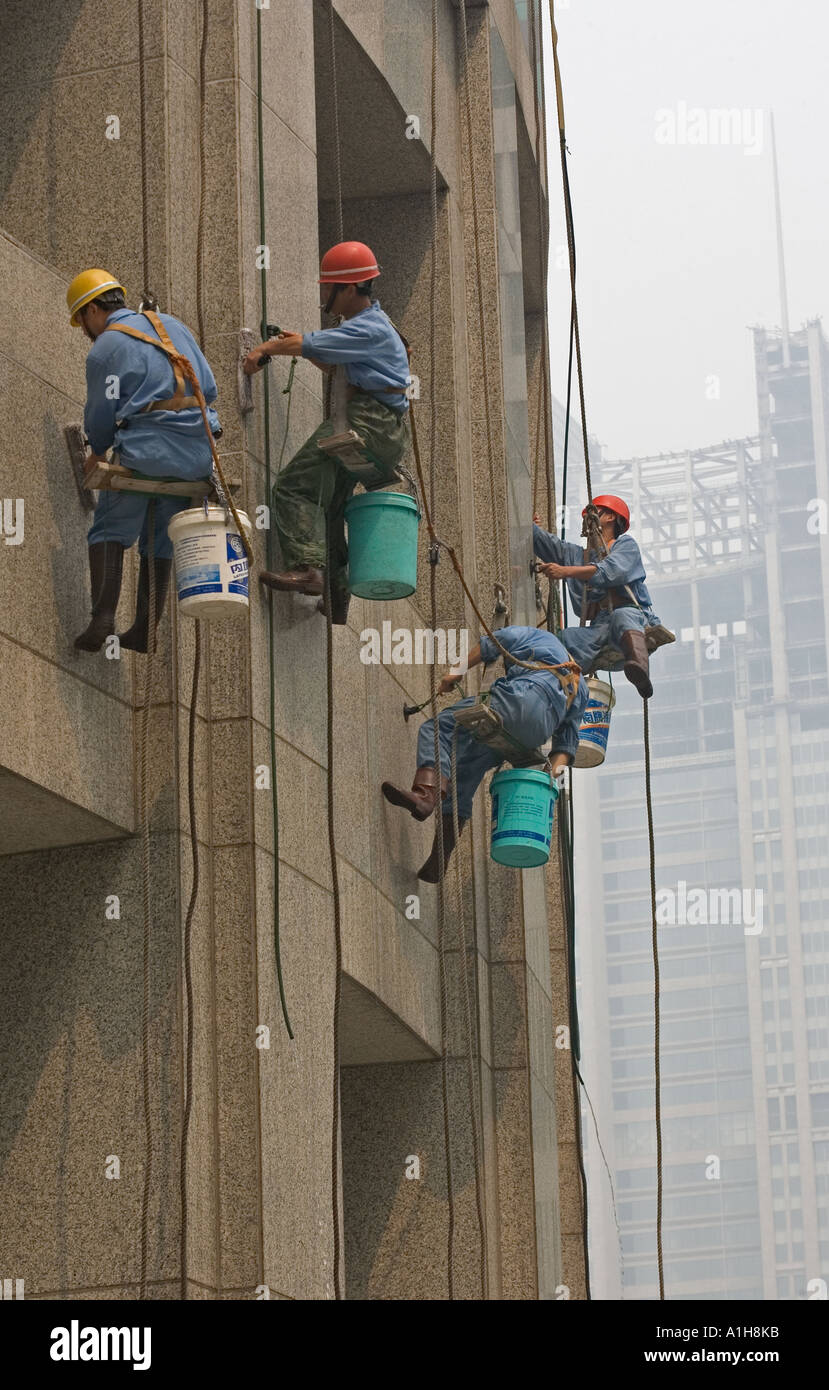 Absailers cleaning high rise buildings Shanghai Stock Photo - Alamy