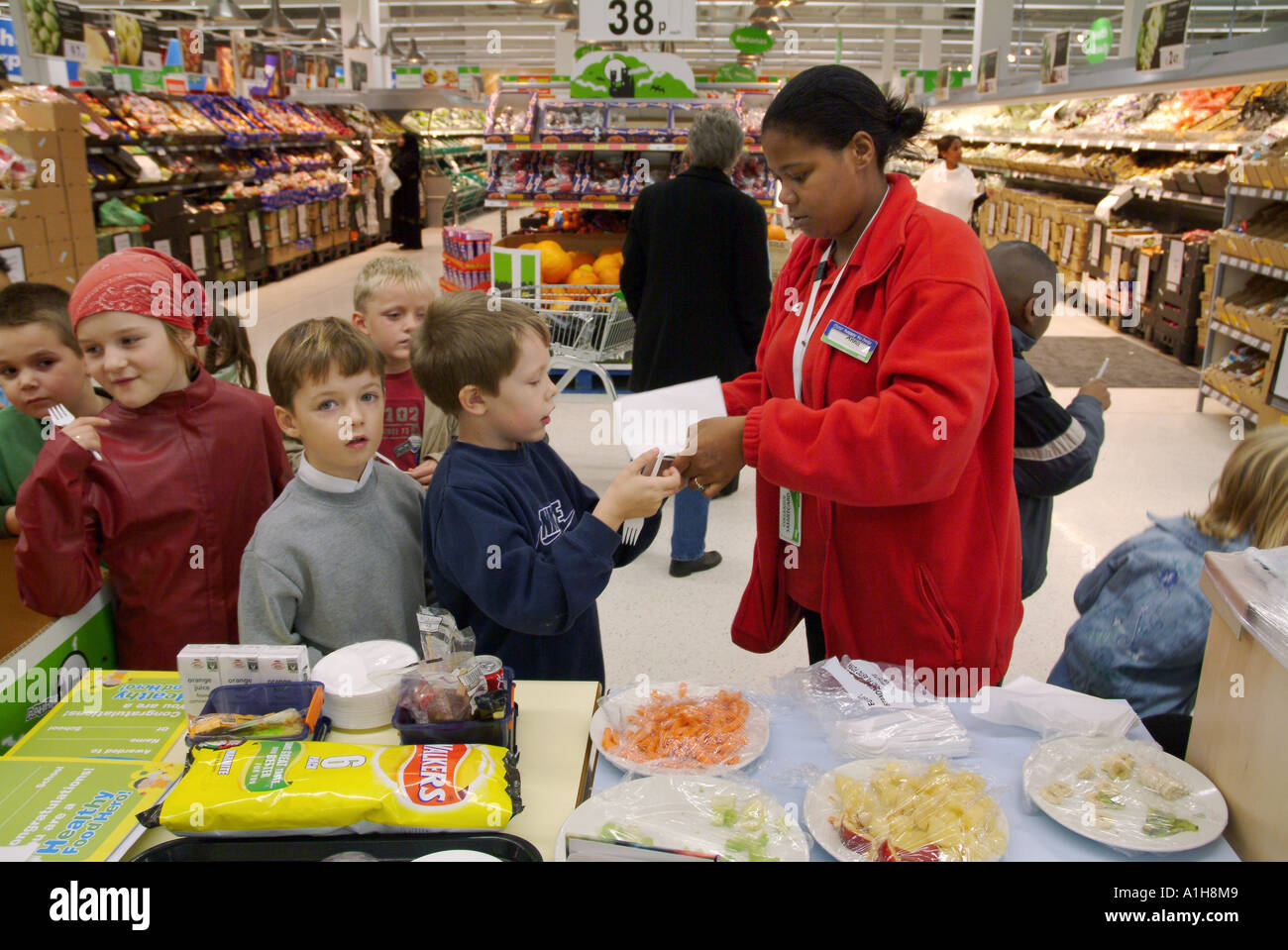 SCHOOL CHILDREN IN ASDA SUPERMARKET WITH EVENT ORGANIZER RECEIVING ...