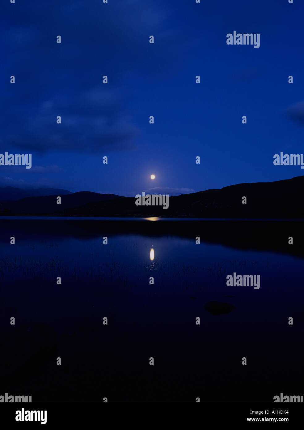 full moon rising over irelands highest mountain Stock Photo - Alamy