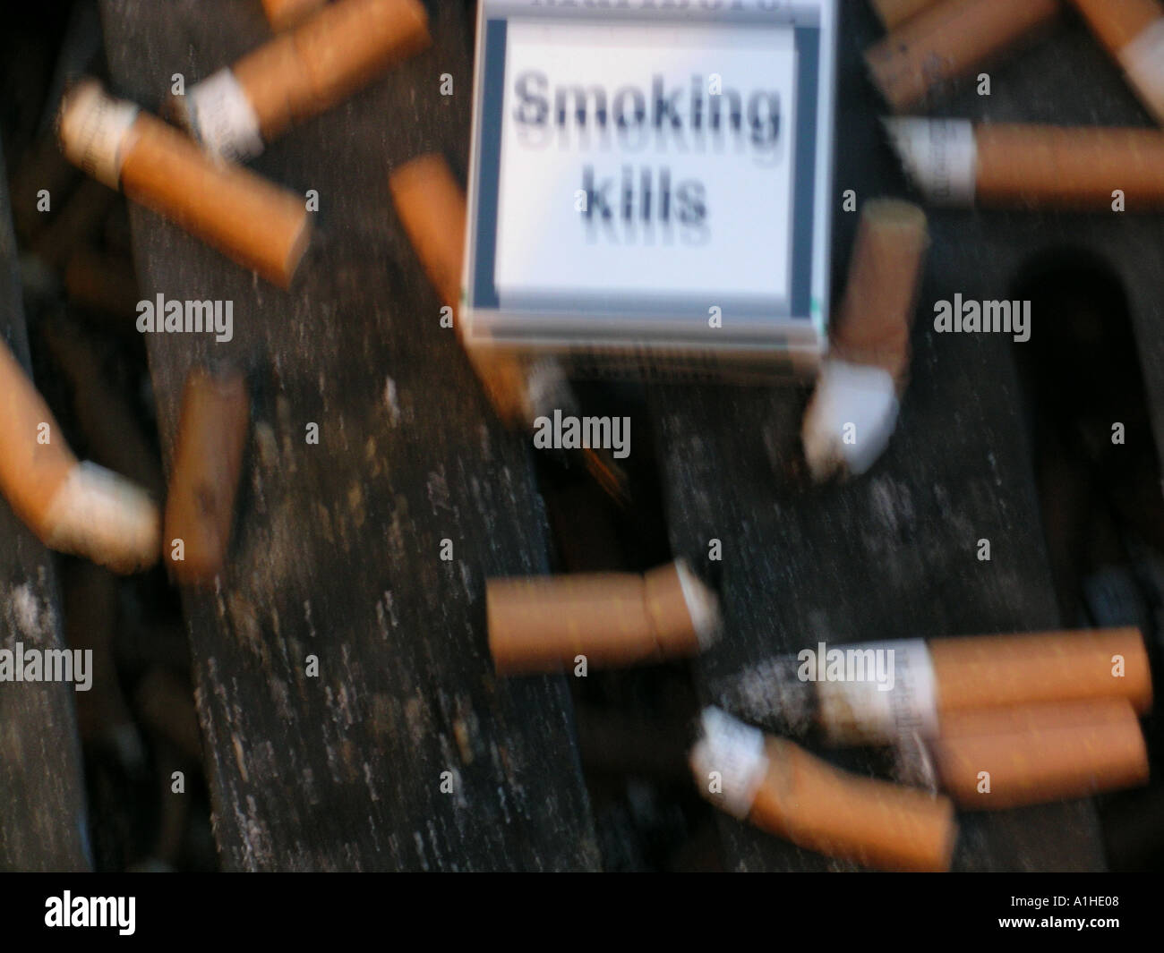 "smoking kills" - sign on packet of cigarettes & butts in ashtray ...