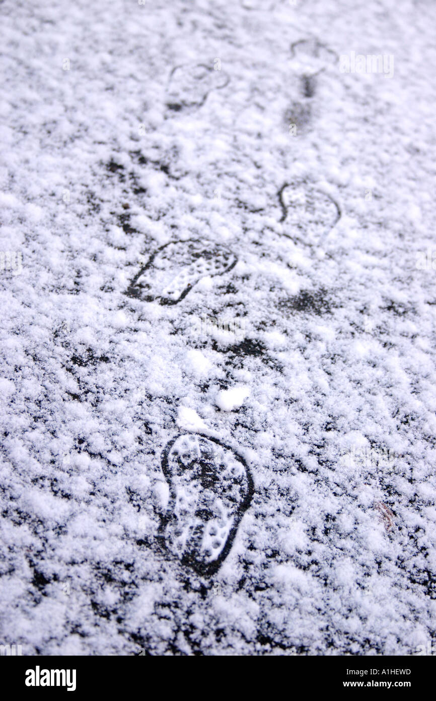 Child's footprints in the snow Stock Photo - Alamy
