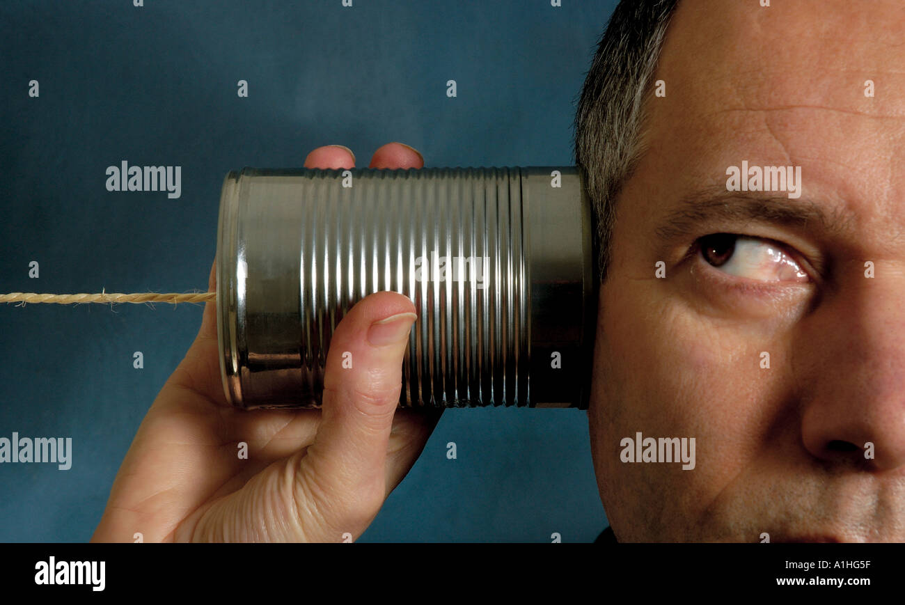 man listening to tin can and string communication phone Stock Photo - Alamy