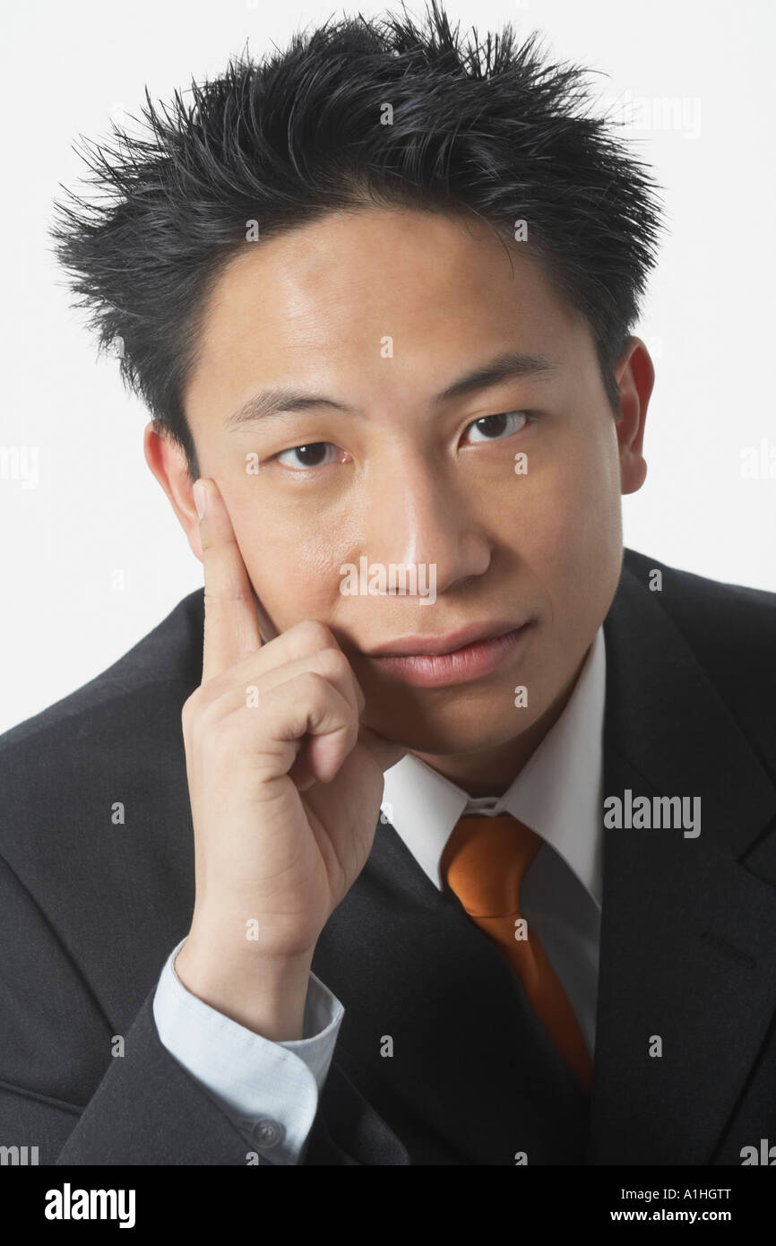 Portrait of a young man with his hand on his face Stock Photo - Alamy