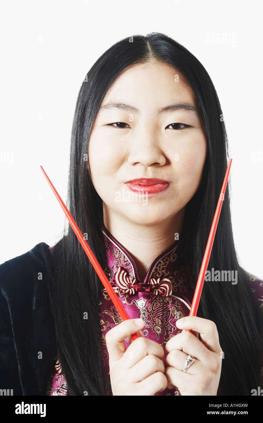 Portrait of a young woman holding chopsticks Stock Photo - Alamy