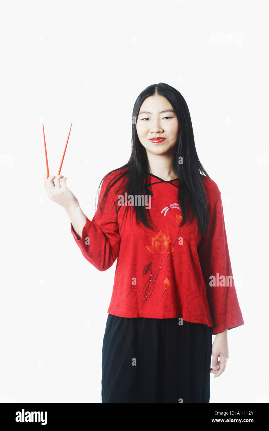 Portrait of a young woman holding chopsticks Stock Photo - Alamy