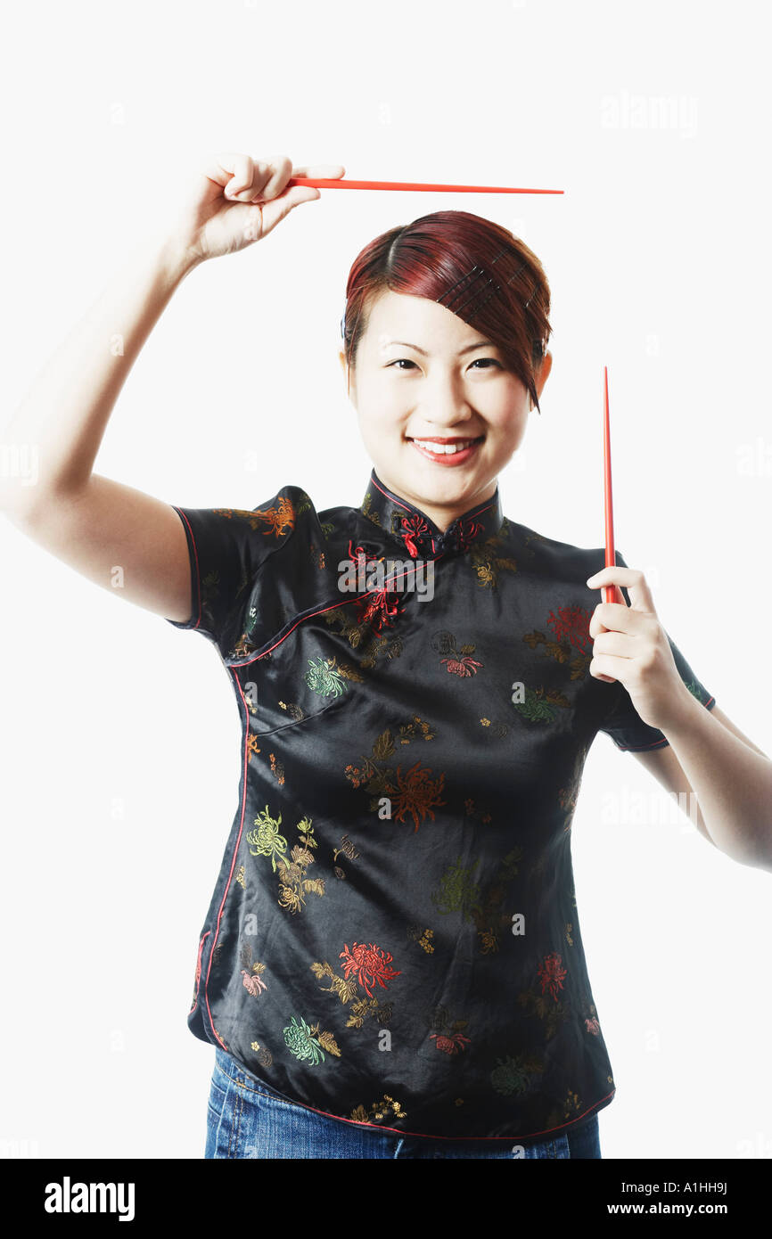 Portrait of a young woman holding chopsticks Stock Photo - Alamy