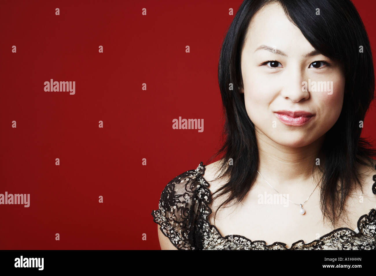 Portrait of a young woman smirking Stock Photo - Alamy