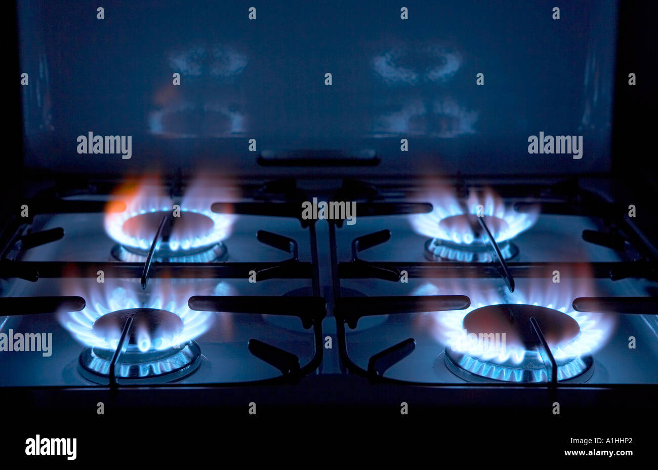 FOUR BURNING RINGS ON GAS COOKER HOB Stock Photo - Alamy