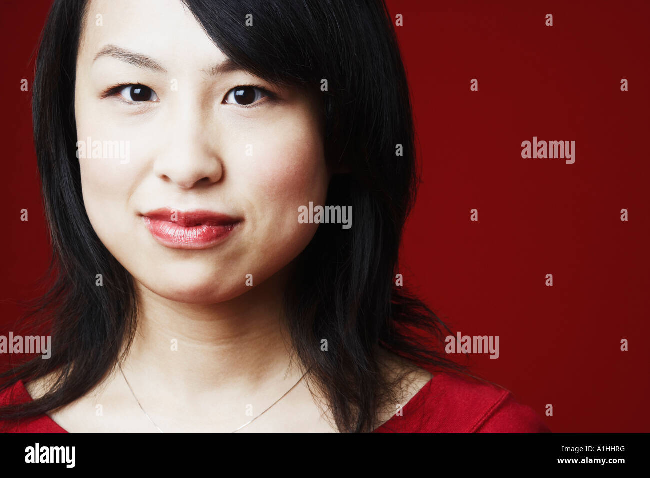 Portrait of a young woman grinning Stock Photo - Alamy