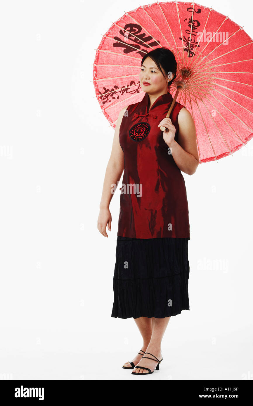 Mid adult woman holding a parasol Stock Photo - Alamy