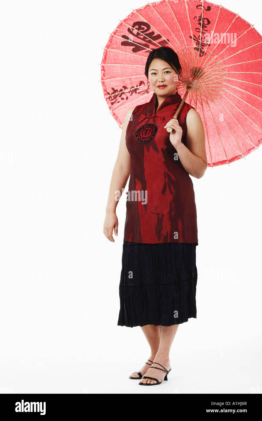 Portrait of a mid adult woman holding a parasol Stock Photo - Alamy