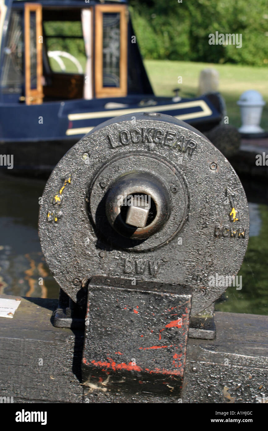 Canal lock gate winding mechanism with narrow boat in background ...