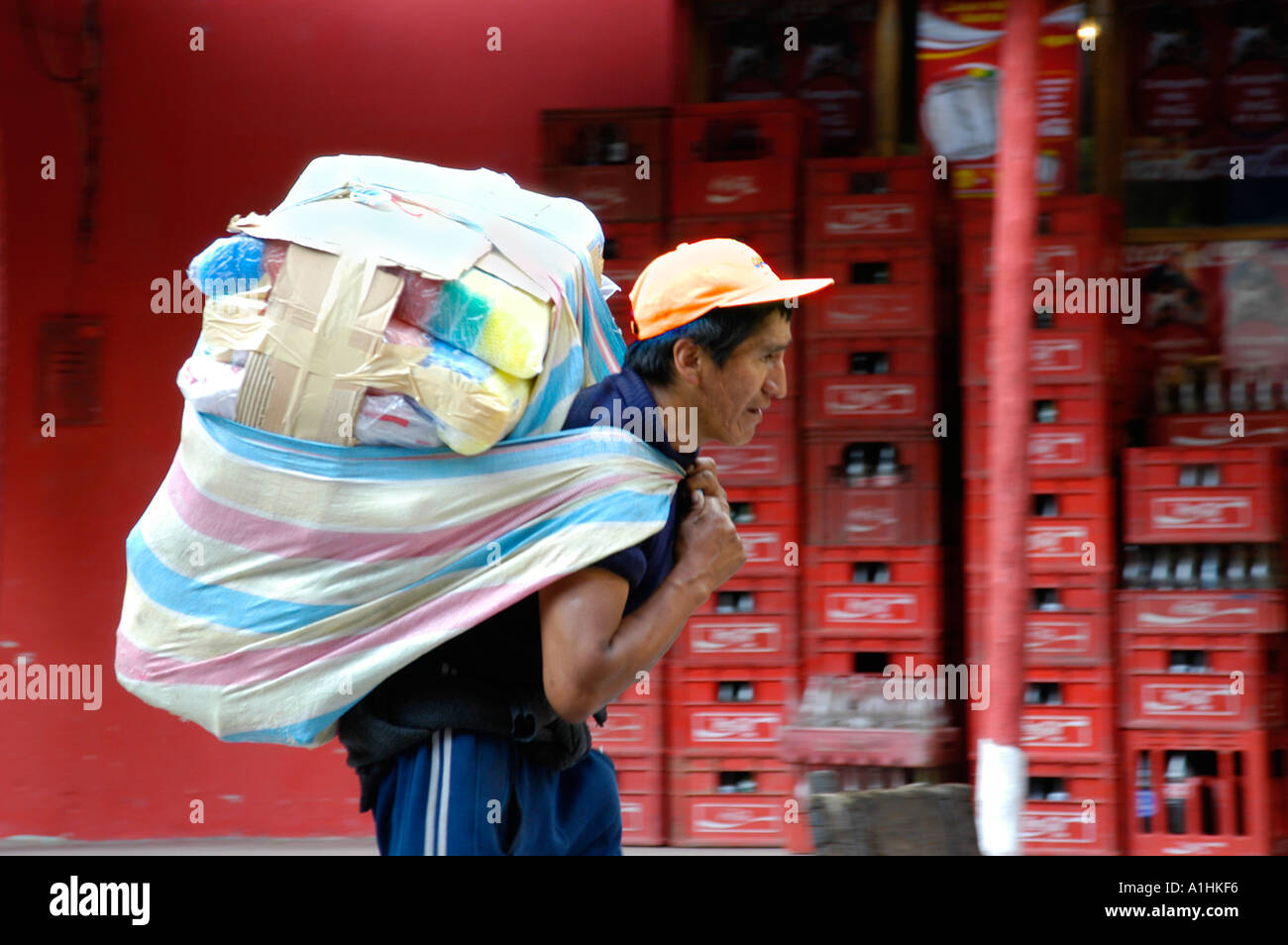 Indian man in Machu Pichu carrying a heavy burden Peru Stock Photo - Alamy