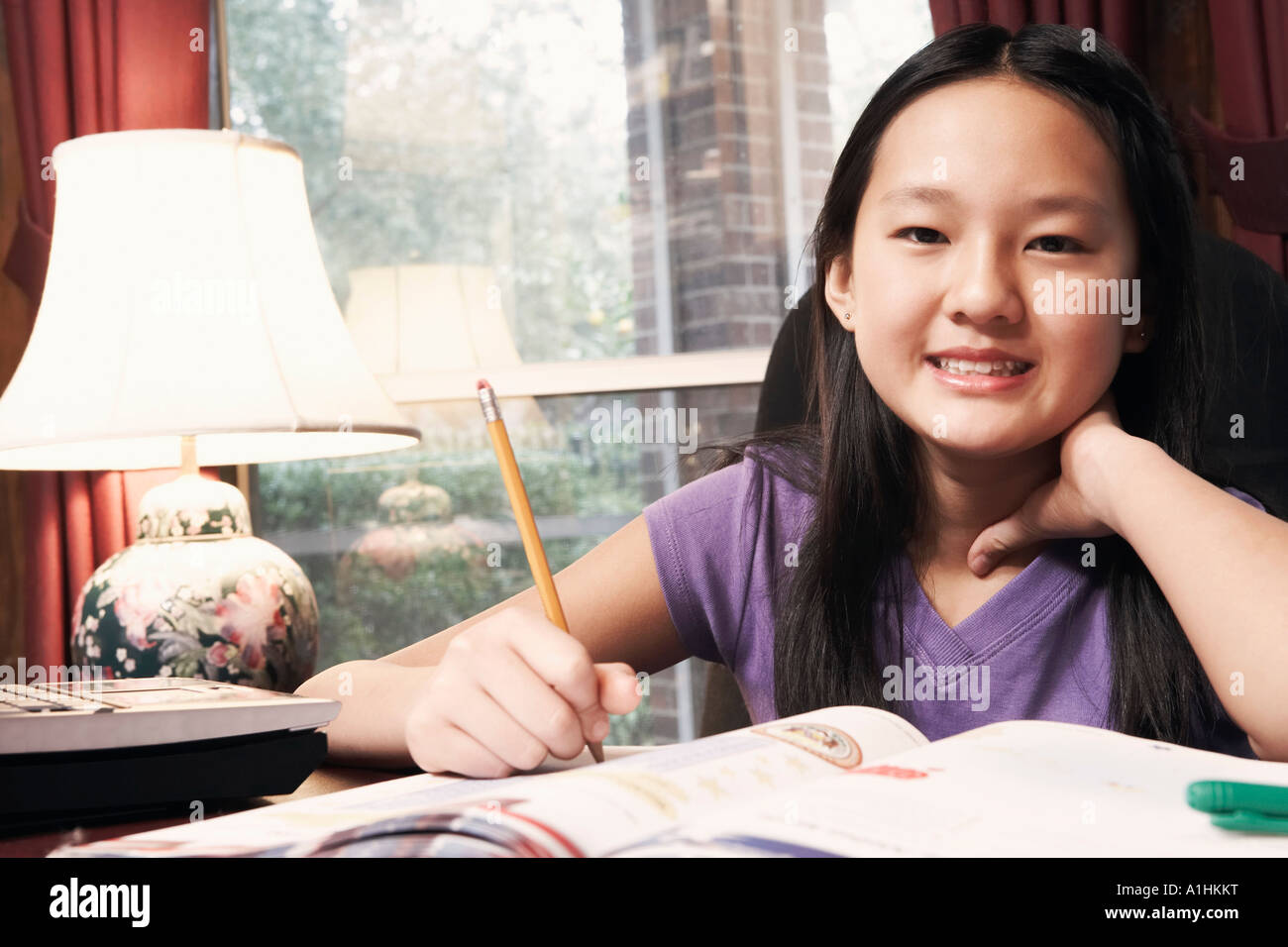 Portrait of a girl holding a pencil Stock Photo - Alamy