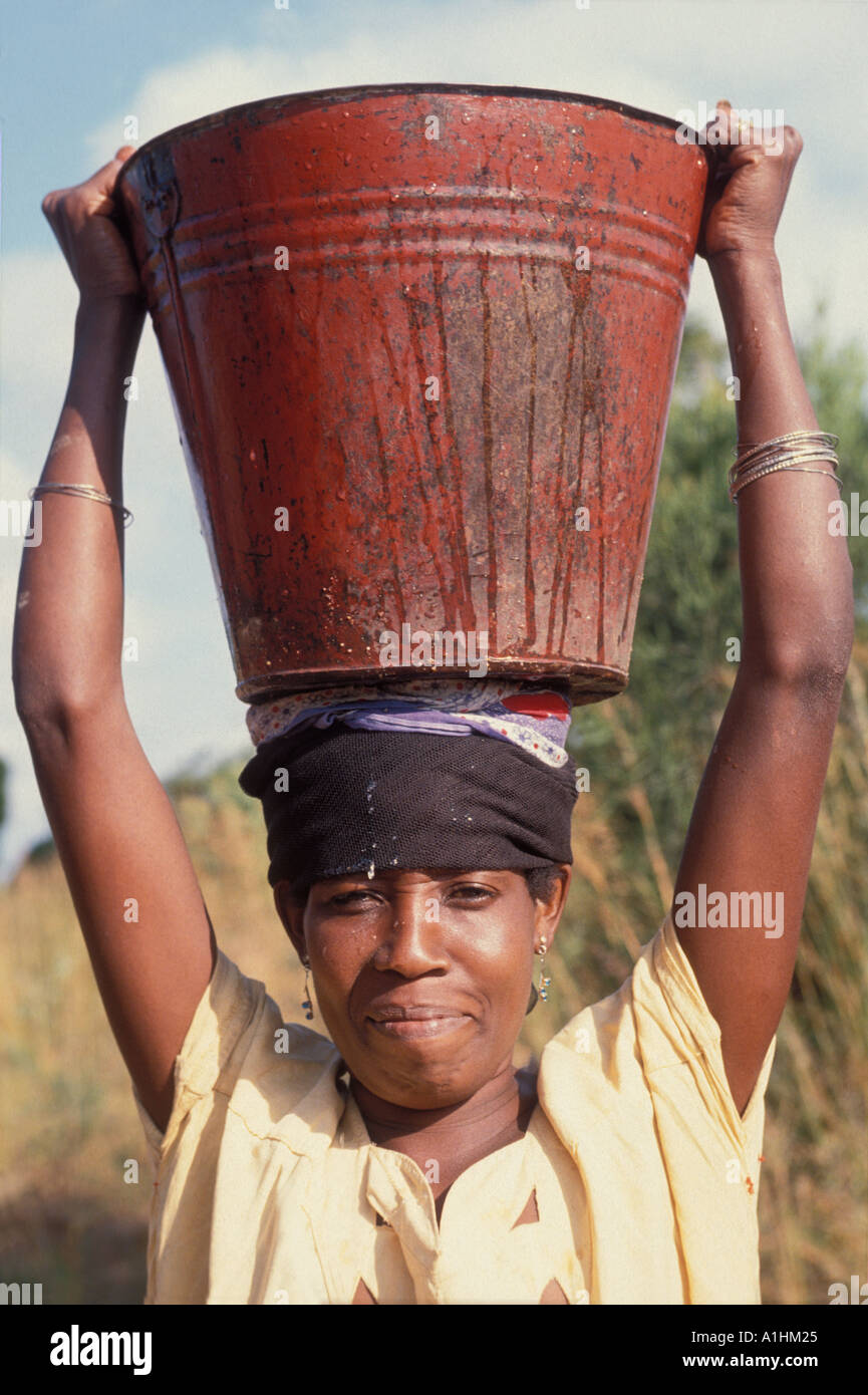 Water in bucket on head hi-res stock photography and images - Alamy