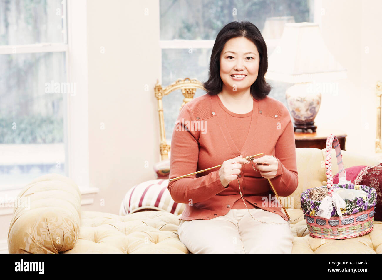 Woman sitting on chair knitting hi-res stock photography and images - Alamy