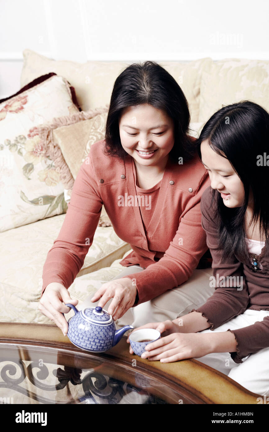 High angle view of a mother pouring tea for her daughter Stock Photo ...