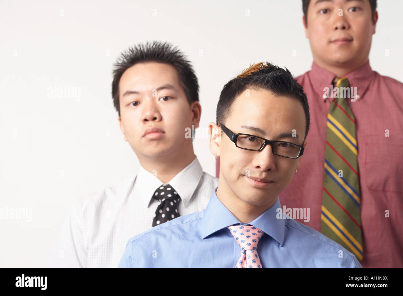 Portrait of three businessmen smiling Stock Photo - Alamy