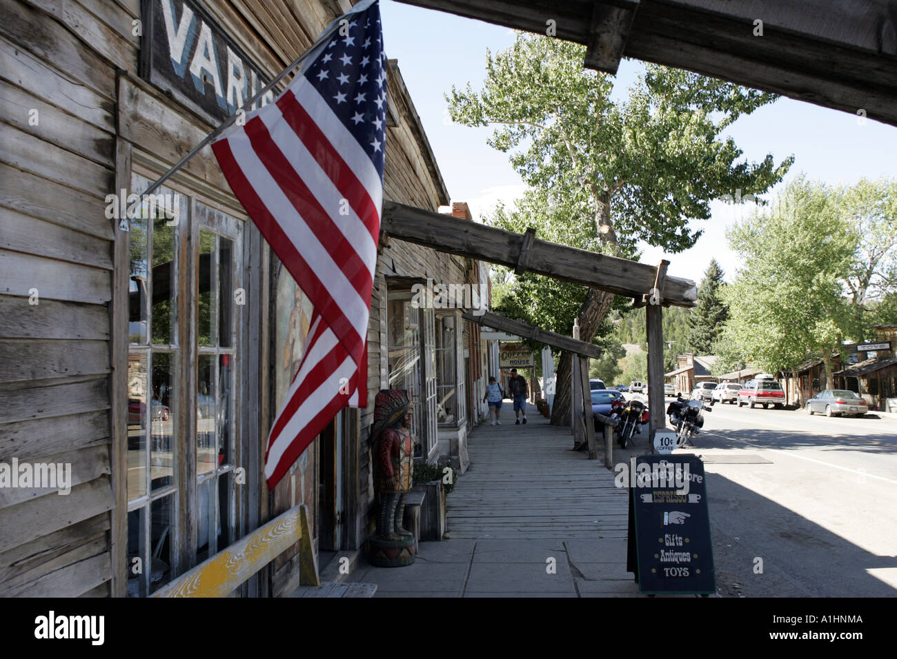 Old western street scene with the US stars and stripes flag flying ...