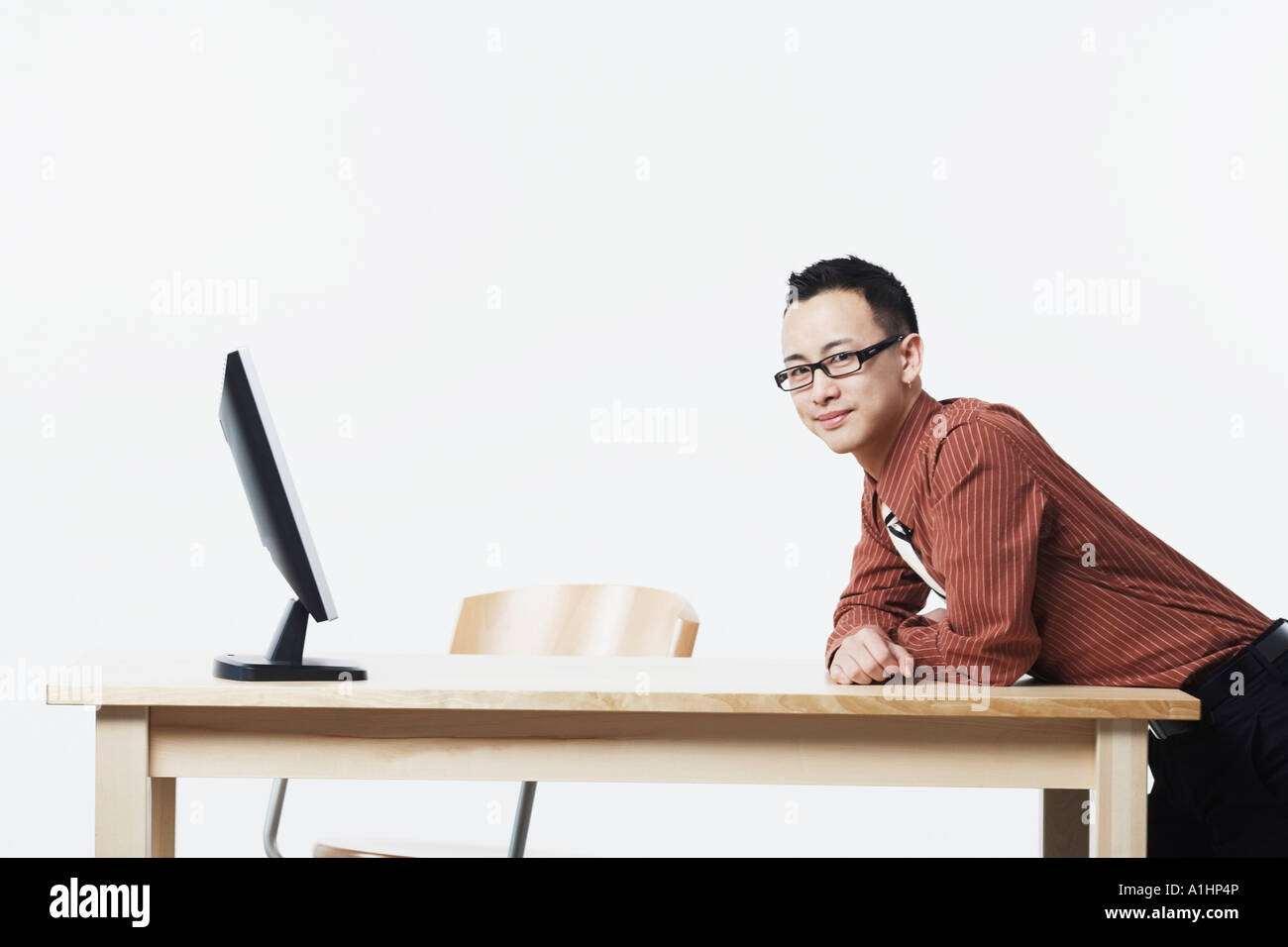 Young man leaning against table hi-res stock photography and images - Alamy