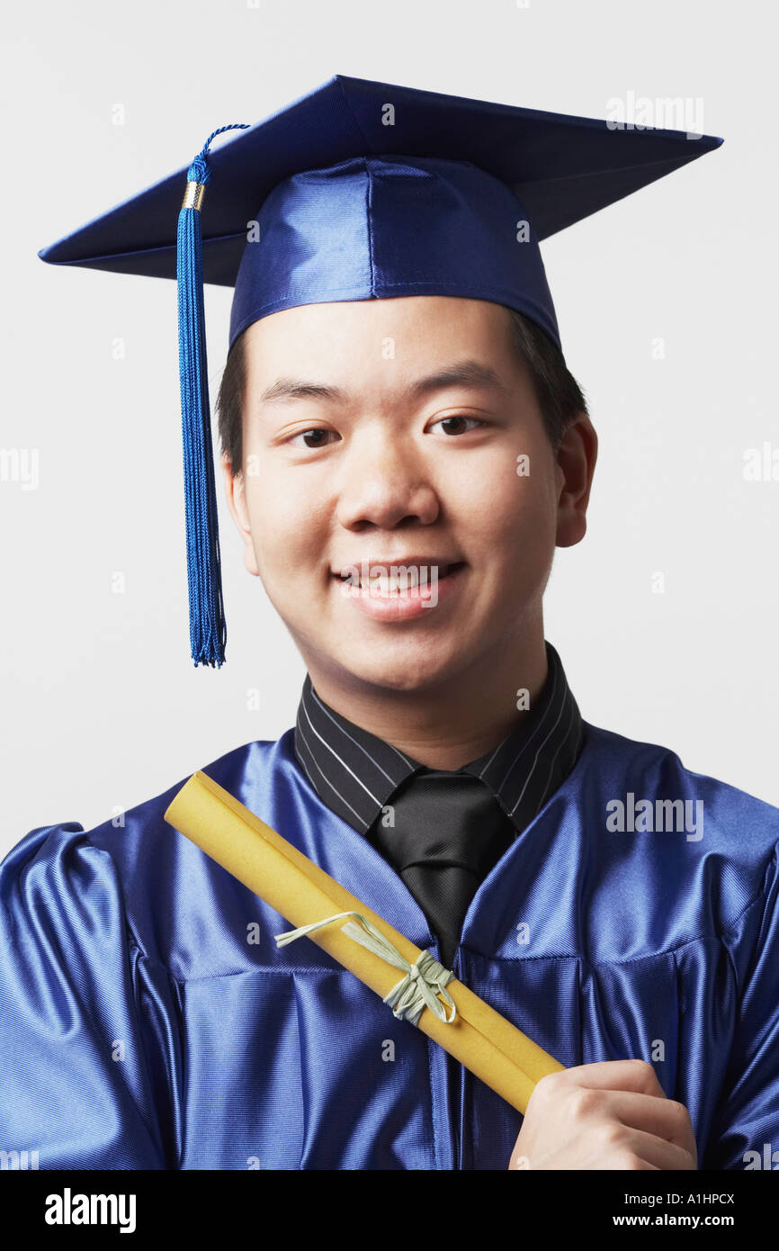 Portrait of a male graduate holding a diploma Stock Photo - Alamy