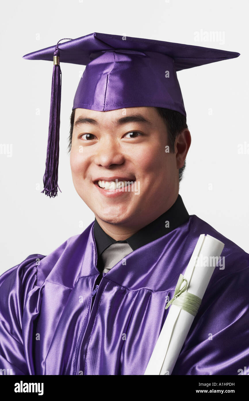 Portrait of a male graduate holding a diploma Stock Photo - Alamy