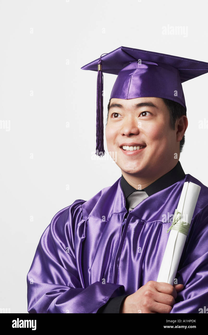 Portrait of a male graduate holding a diploma Stock Photo - Alamy
