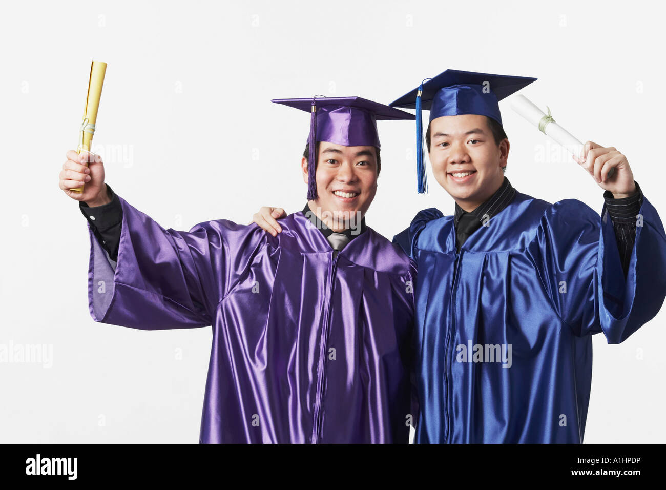 Portrait of two male graduates holding diplomas Stock Photo - Alamy