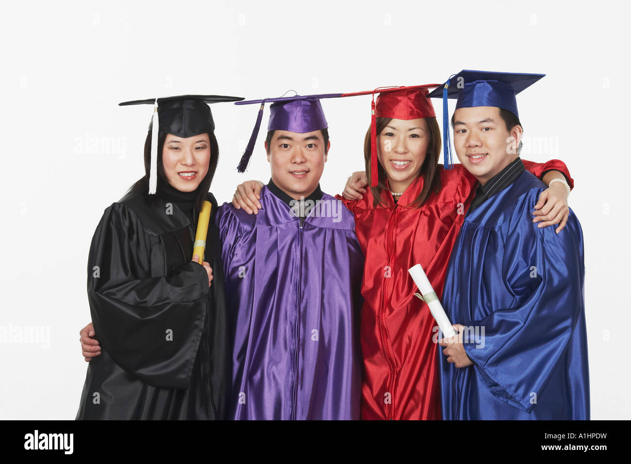 Portrait of two male and two female graduates Stock Photo - Alamy