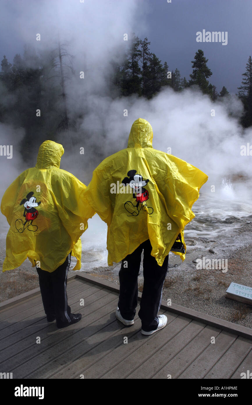Two people in yellow rain capes on boardwalk looking at the Spasmodic ...