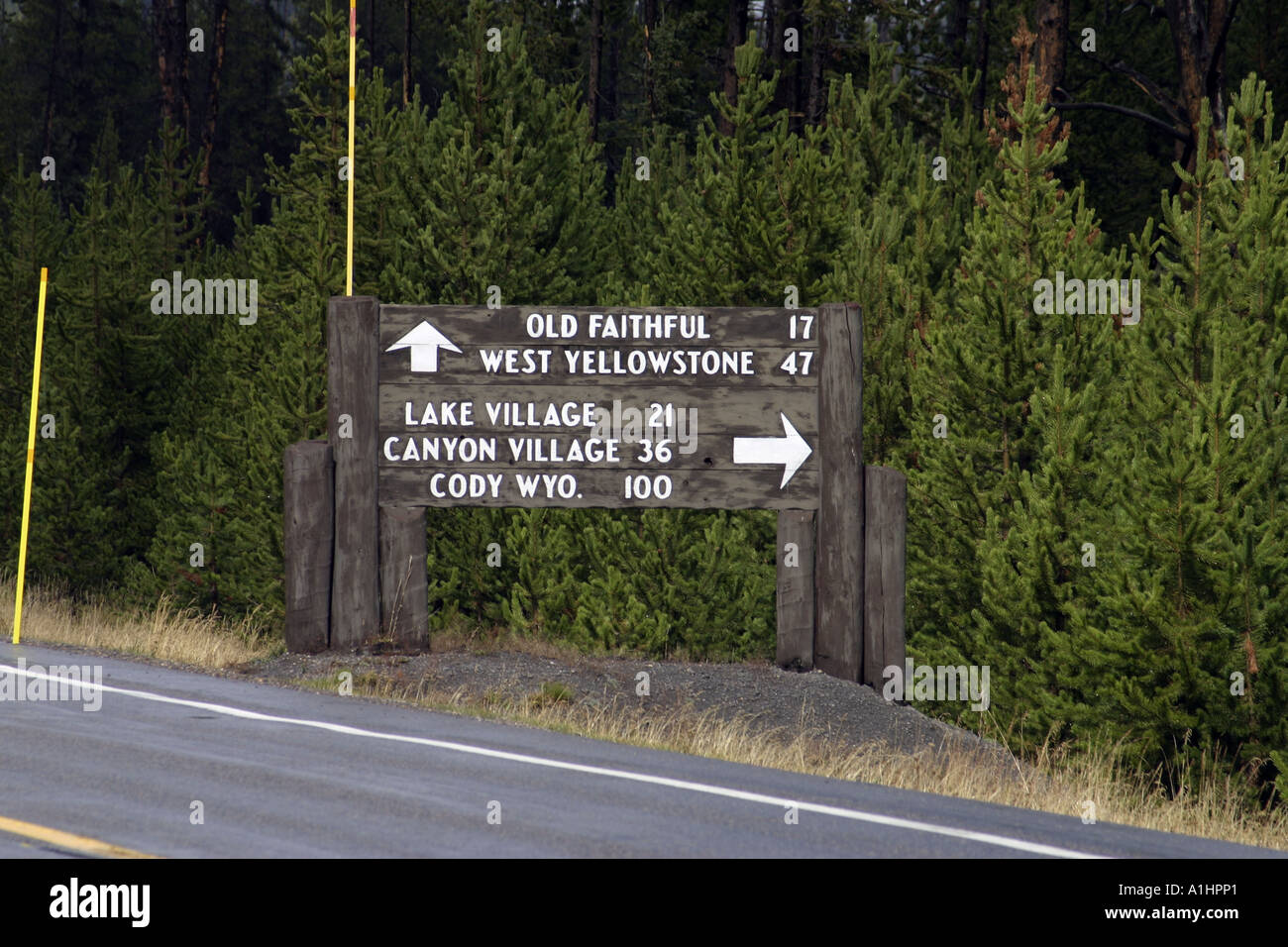 Wooden signpost showing places and distances in Yellowstone National ...