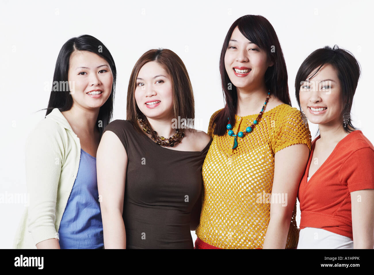Portrait of four young women smiling Stock Photo - Alamy