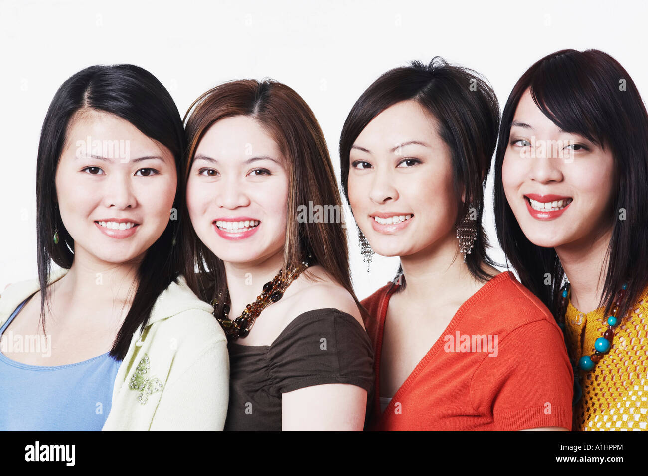 Portrait of four young women smiling Stock Photo - Alamy
