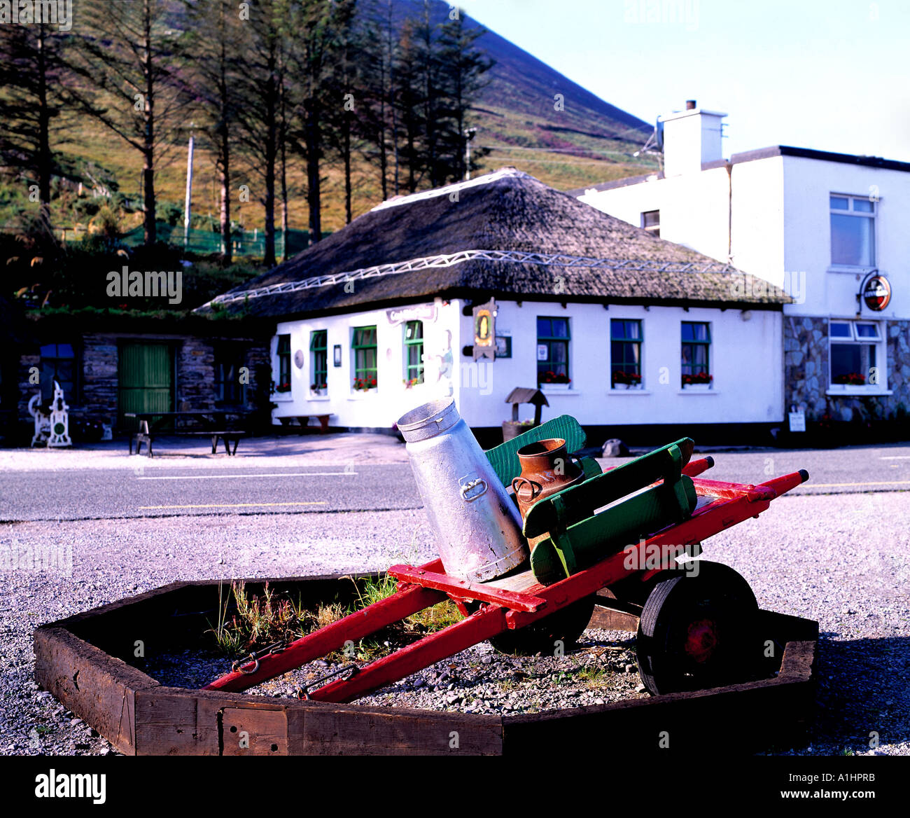 milk cart with milk churn tank lying outside an old irish pub on the ...