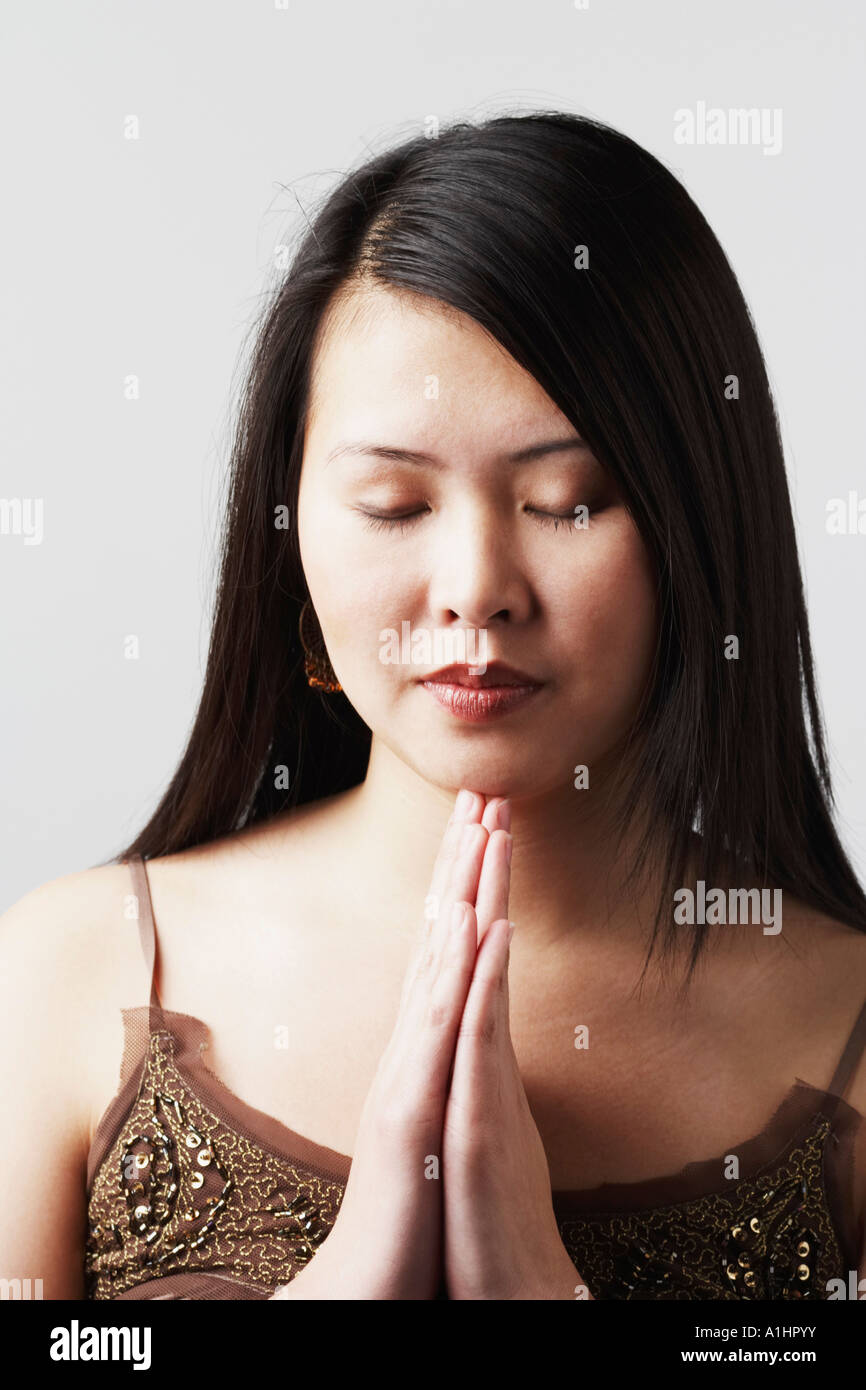 Close-up of a young woman in a prayer position Stock Photo - Alamy