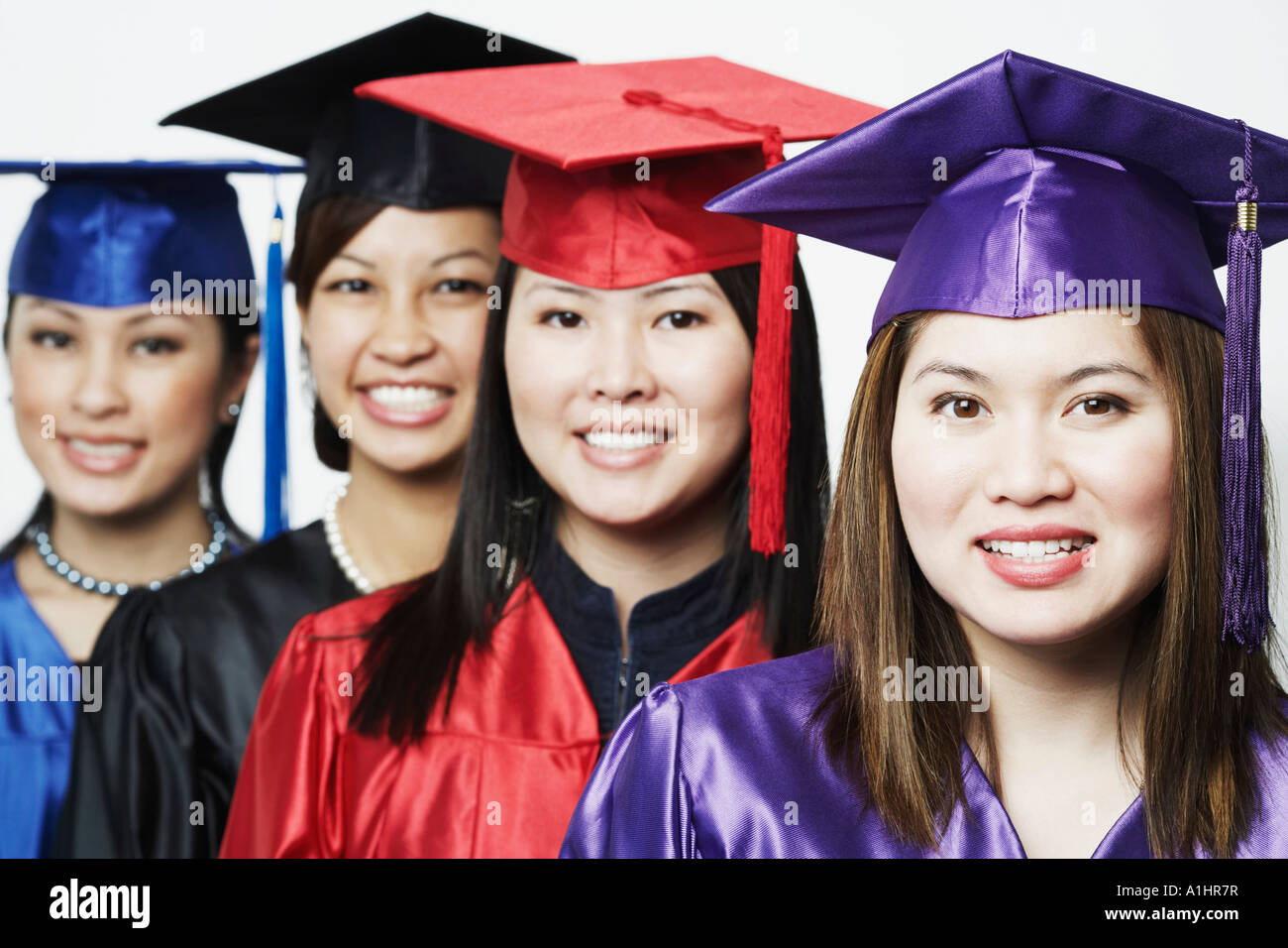 Portrait of four female graduates standing in a row Stock Photo - Alamy