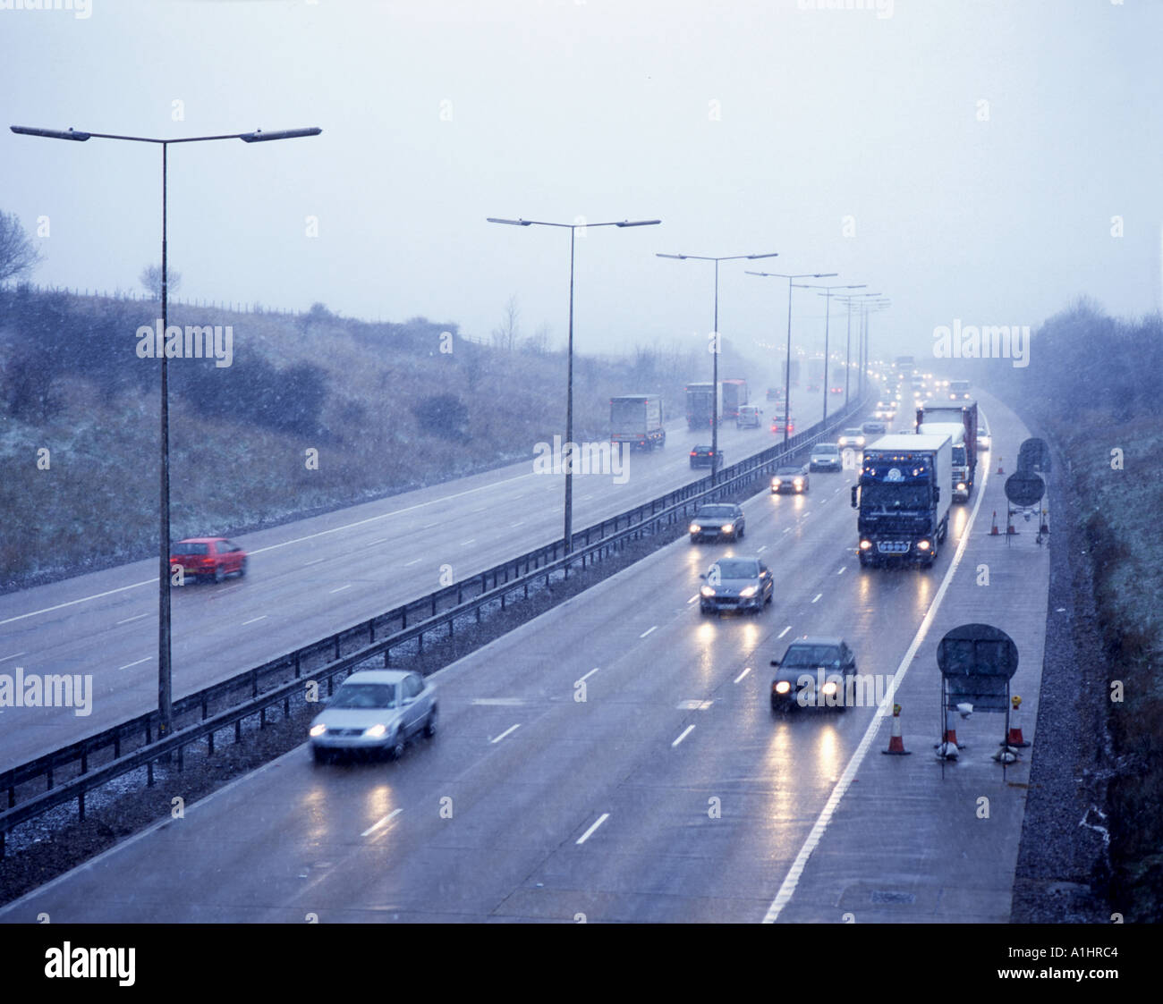 Traffic on the M25 motorway in Essex in a snow storm Stock Photo - Alamy