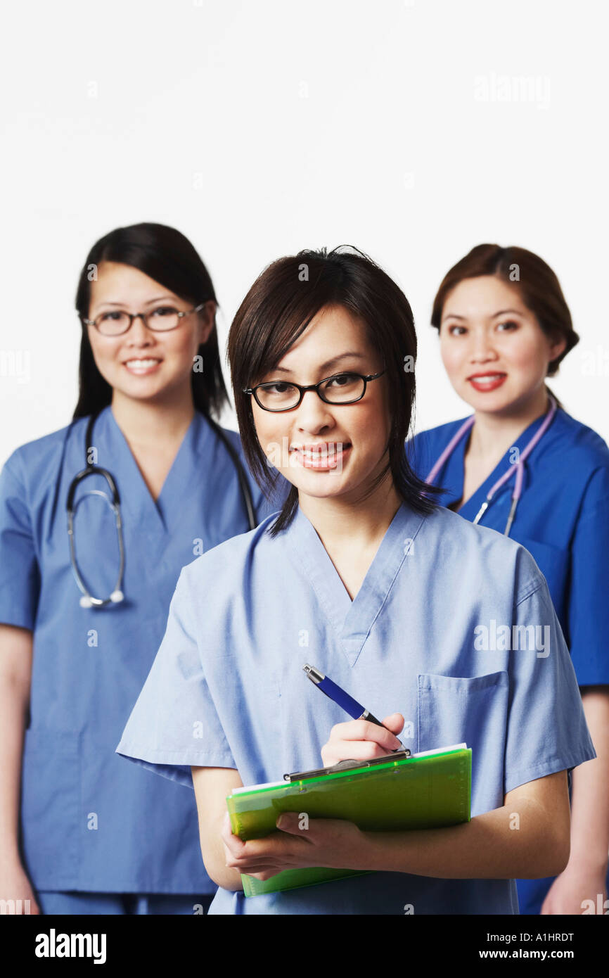 Portrait of three female doctors smiling Stock Photo - Alamy