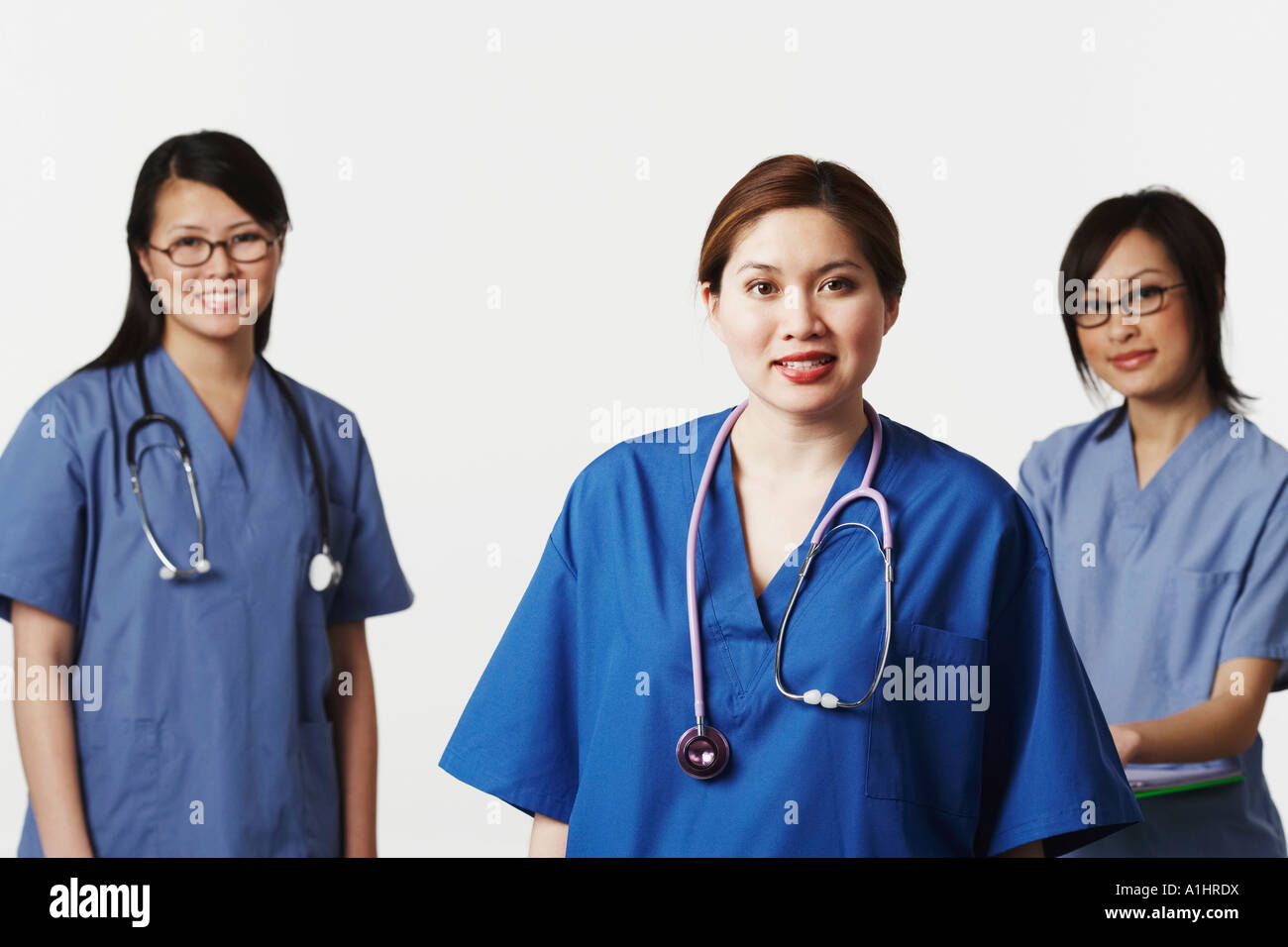 Portrait of three female doctors smiling Stock Photo - Alamy