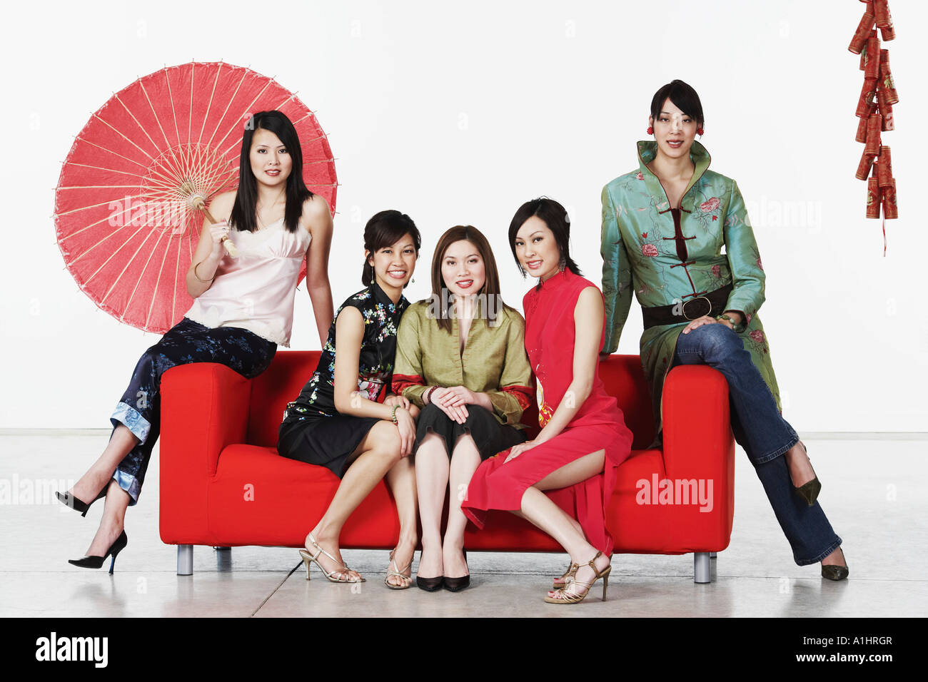 Portrait of five young women sitting on a couch Stock Photo - Alamy