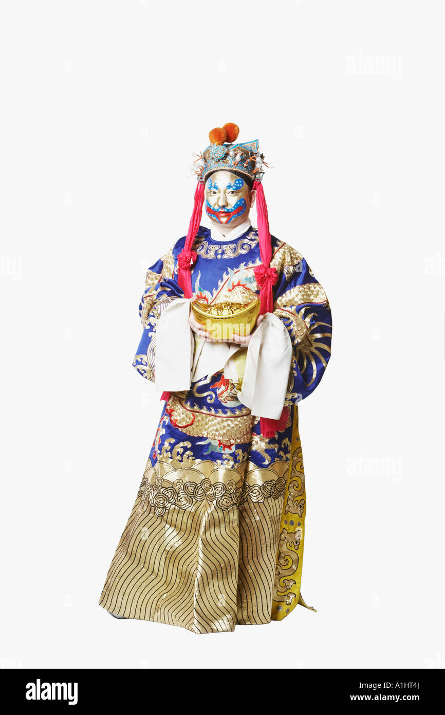Portrait of a male Chinese opera performer holding a bowl full of gold ...