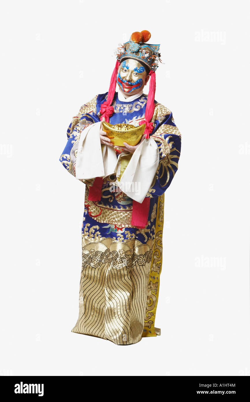 Portrait of a male Chinese opera performer holding a bowl full of gold ...