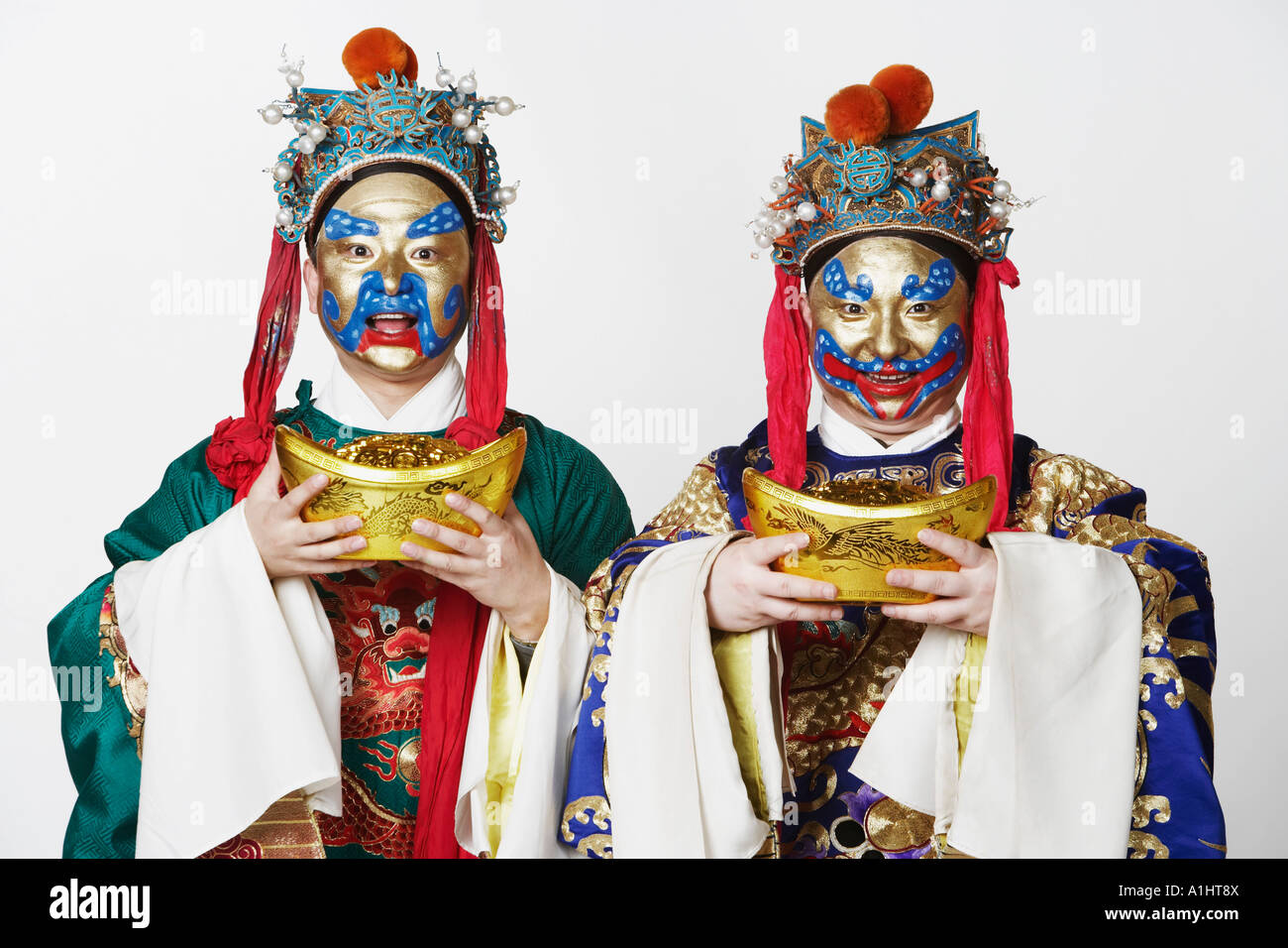 Portrait of two male Chinese opera performers holding bowls full of ...