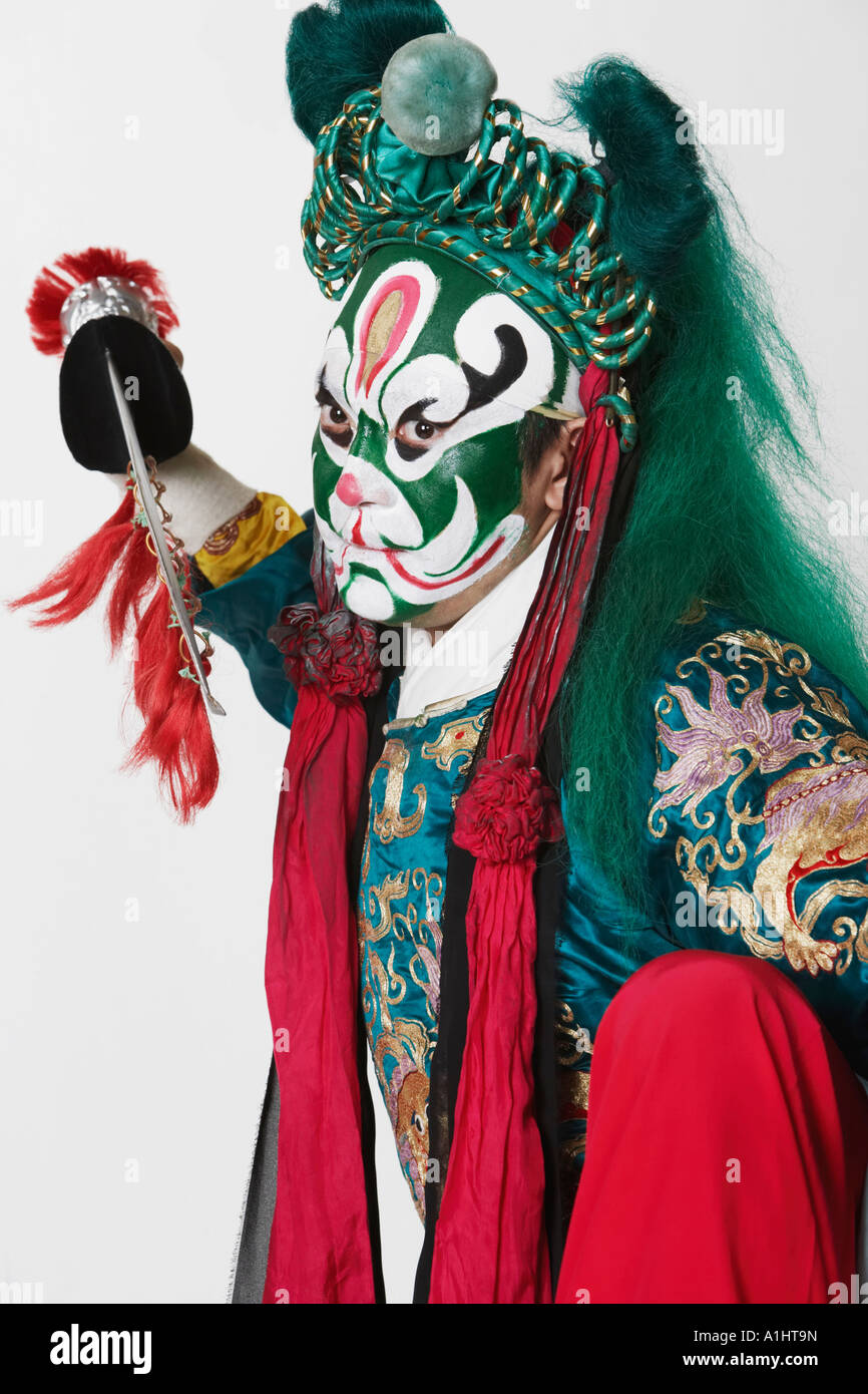 Portrait of a male Chinese opera performer holding a weapon Stock Photo ...