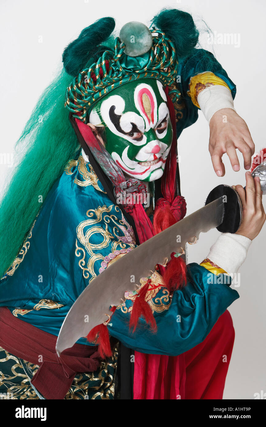 Side profile of a male Chinese opera performer holding a weapon Stock ...