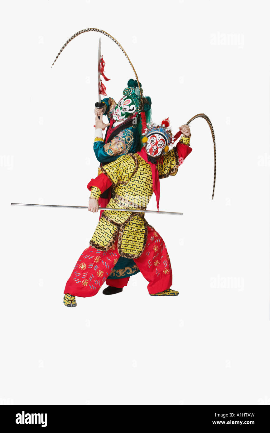 Two male Chinese opera performers gesturing with weapons Stock Photo ...