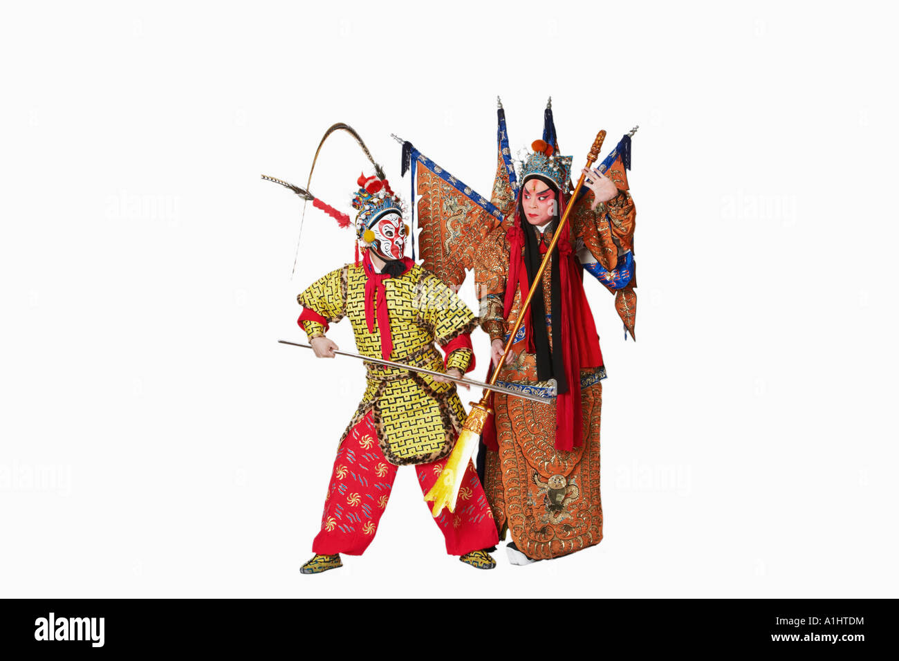 Two male Chinese opera performers gesturing with weapons Stock Photo ...