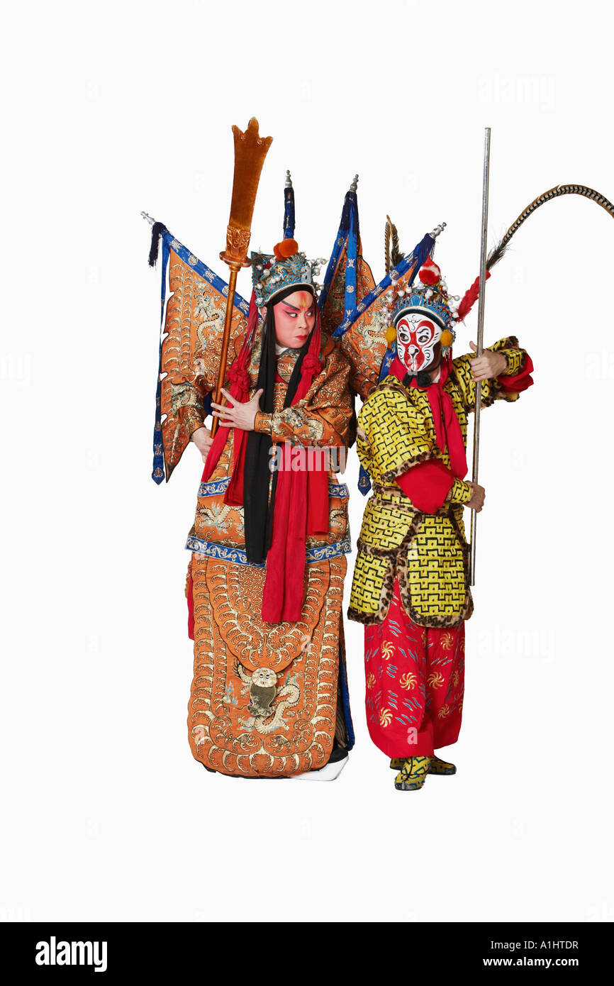 Two male Chinese opera performers gesturing with weapons Stock Photo ...