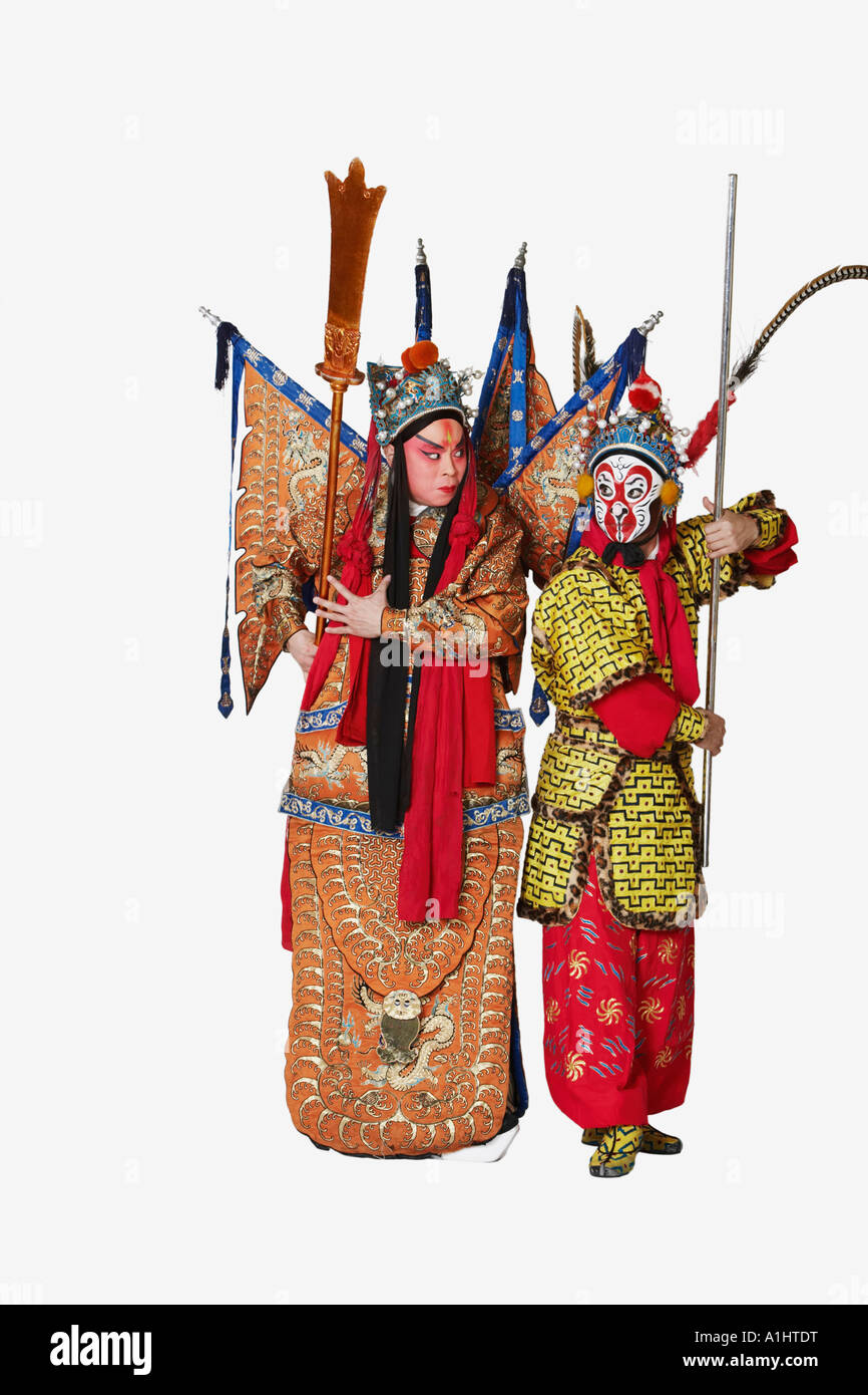 Two male Chinese opera performers gesturing with weapons Stock Photo ...