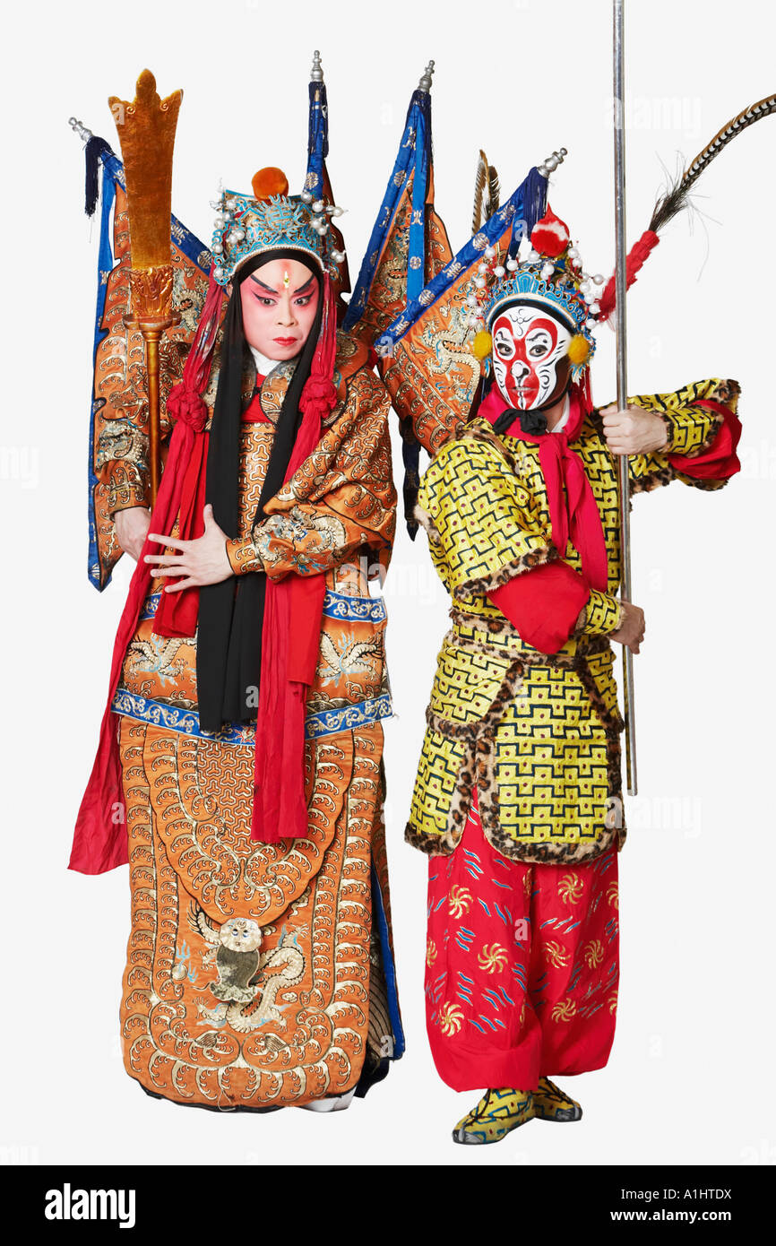 Two male Chinese opera performers gesturing with weapons Stock Photo ...